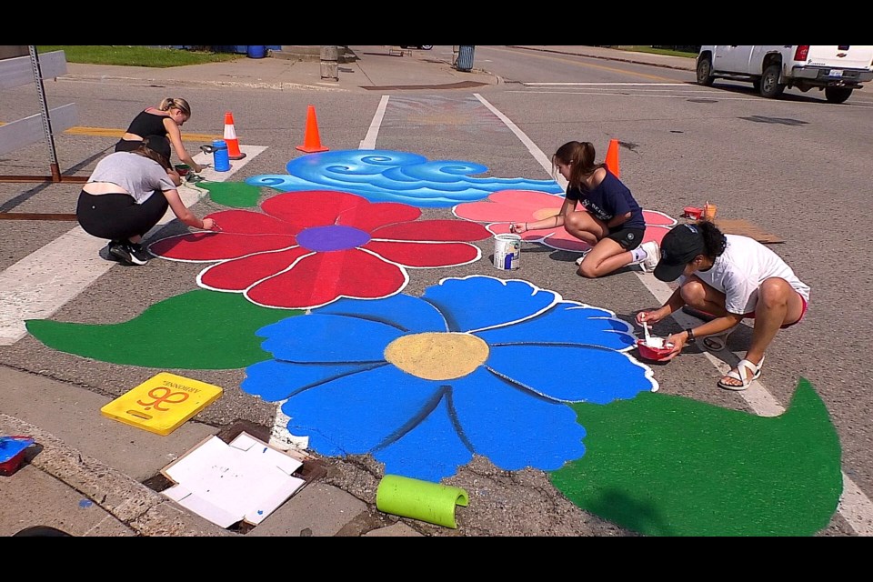 Volunteers paint vibrant designs on crosswalks - SooLeader Volunteers paint vibrant designs on crosswalks - SooLeader